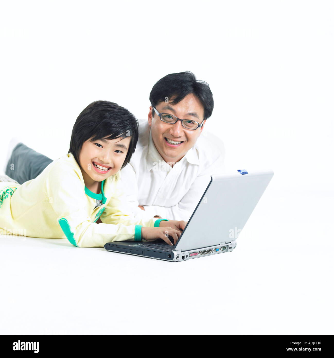 A dad and his son are watching a notebook computer with a smile Stock ...