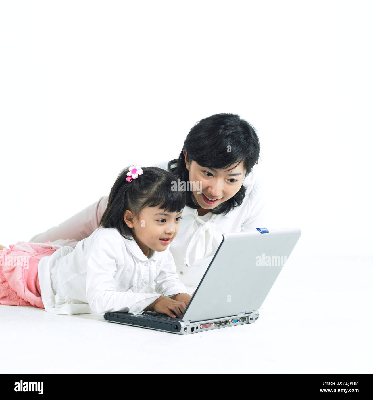 A mom and her daughter are watching a notebook computer with a smile ...