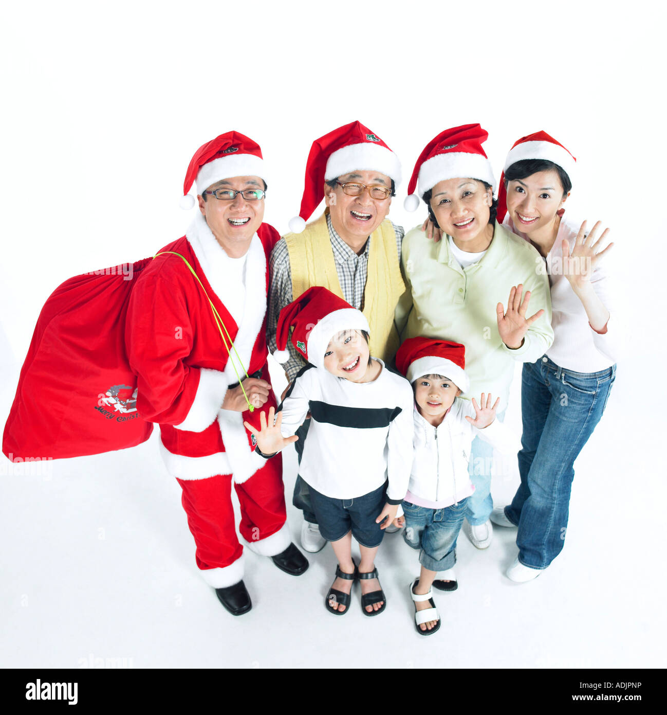 A Korean family is putting Santa Claus hat with a smile Stock Photo - Alamy