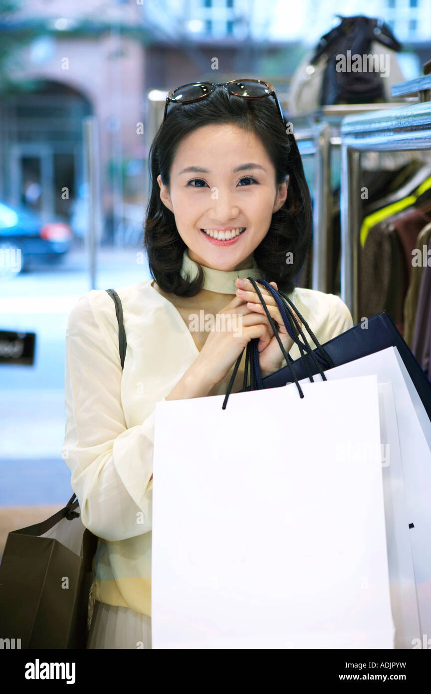 A woman is shopping in the shopping center with a smile Stock Photo - Alamy