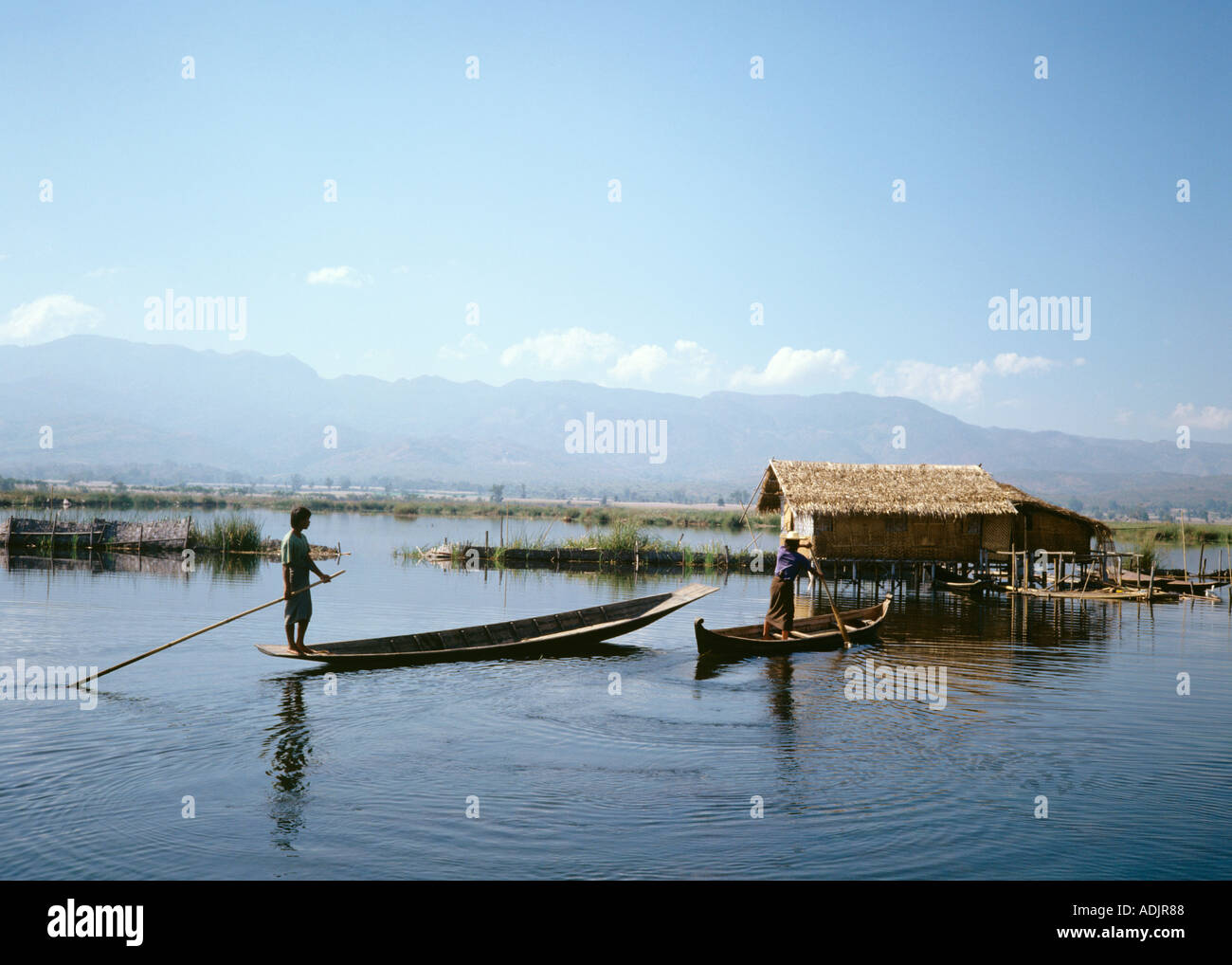 Myanmar Inle Lake area stilt house dwellers in their boats Stock Photo ...