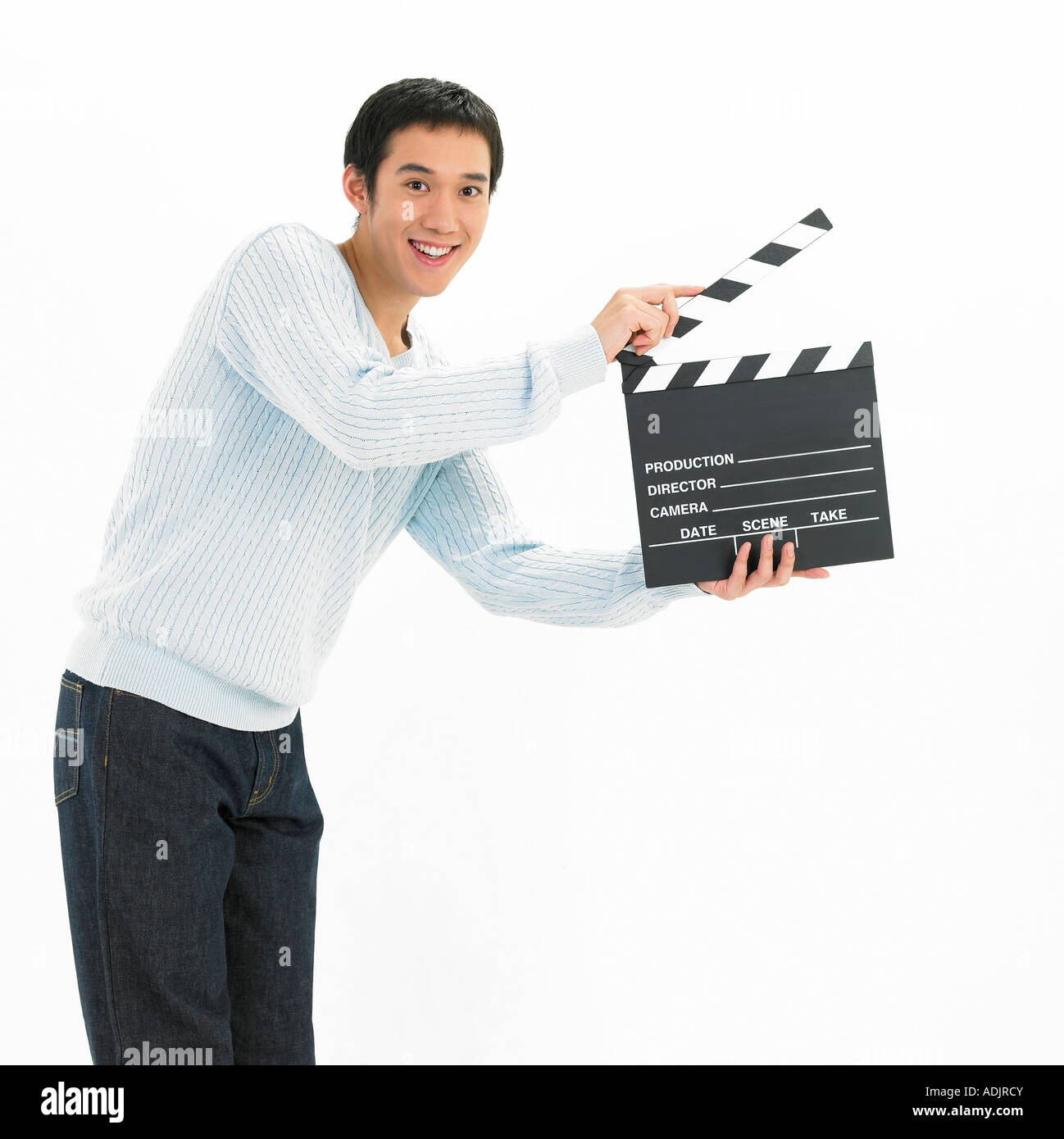 A smiling man is holding a clapper board Stock Photo - Alamy