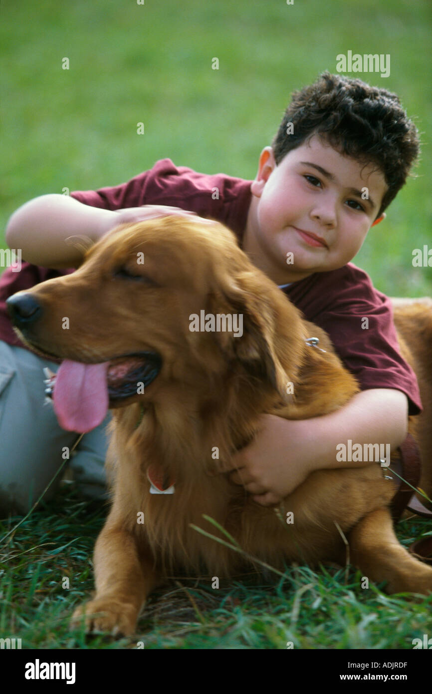 Portrait of a boy hugging his dog Stock Photo - Alamy