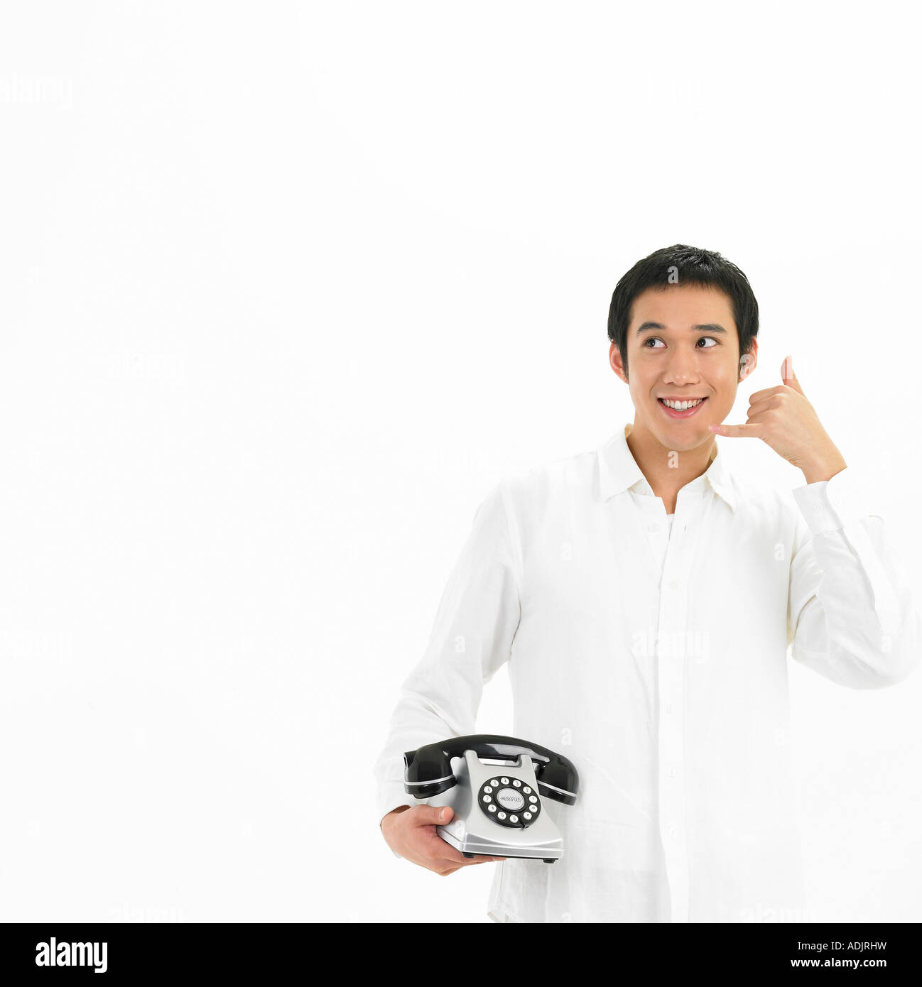 A man is holding a telephone and going to call with a smile Stock Photo ...