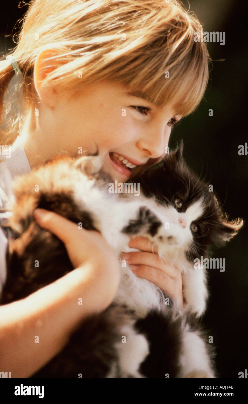 Close-up of a girl holding cats Stock Photo - Alamy