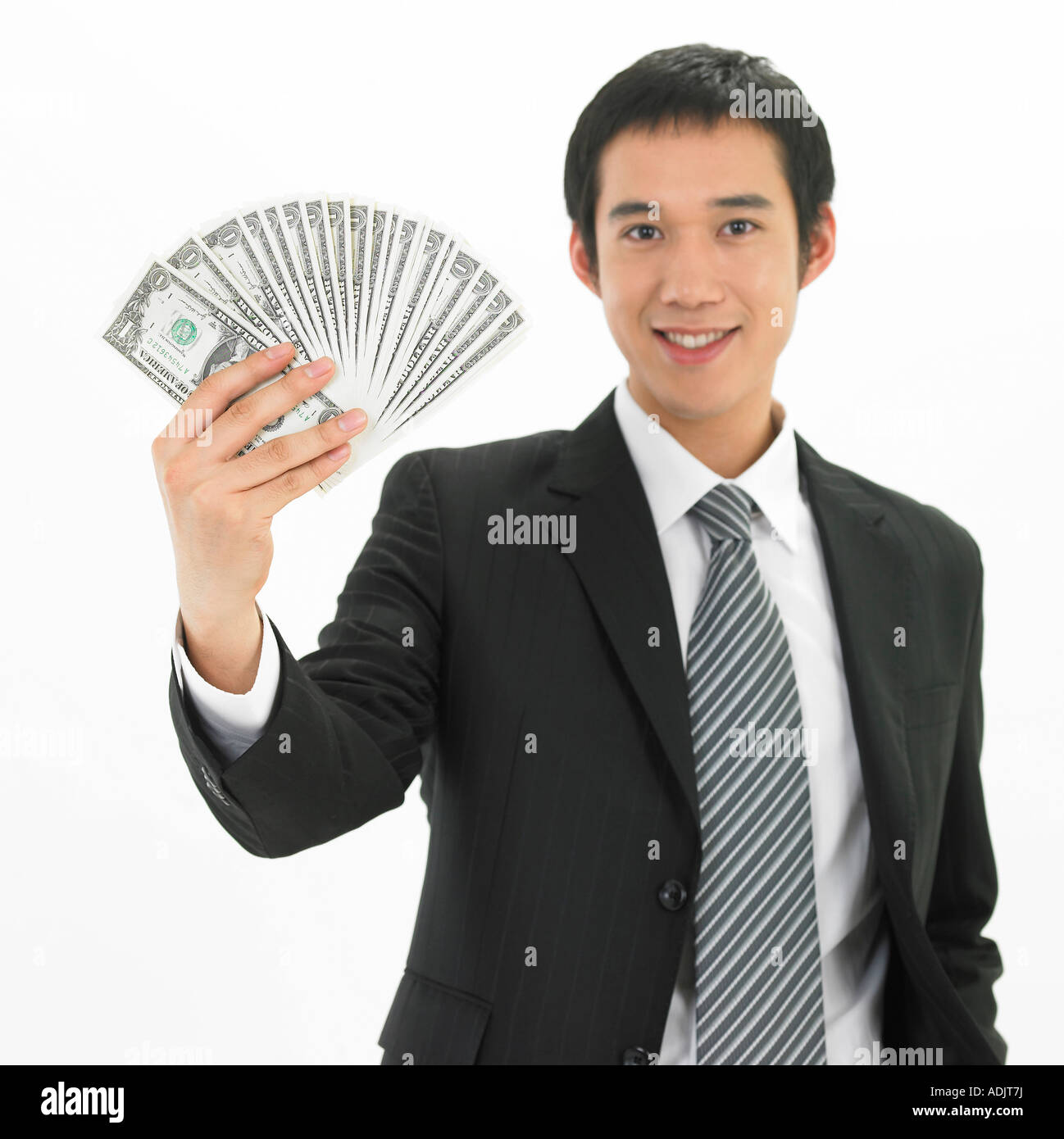 A smiling man holding paper money Stock Photo - Alamy