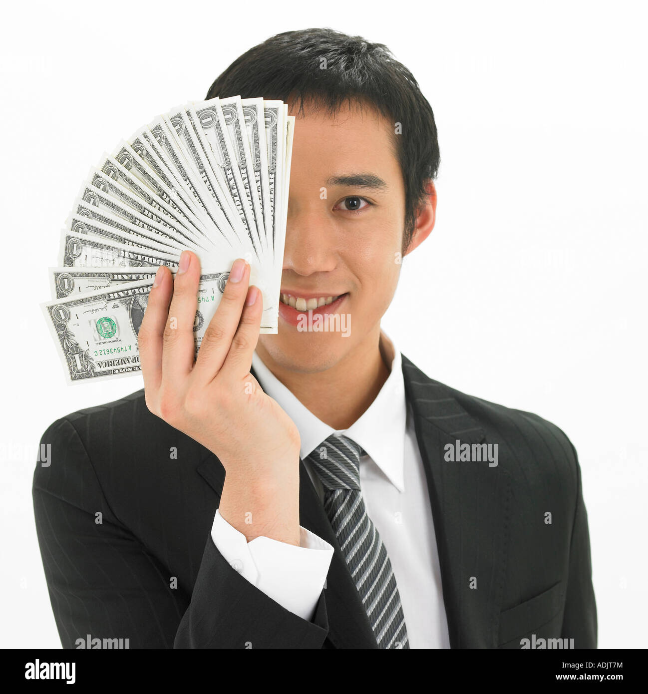 A smiling man holding paper money Stock Photo - Alamy