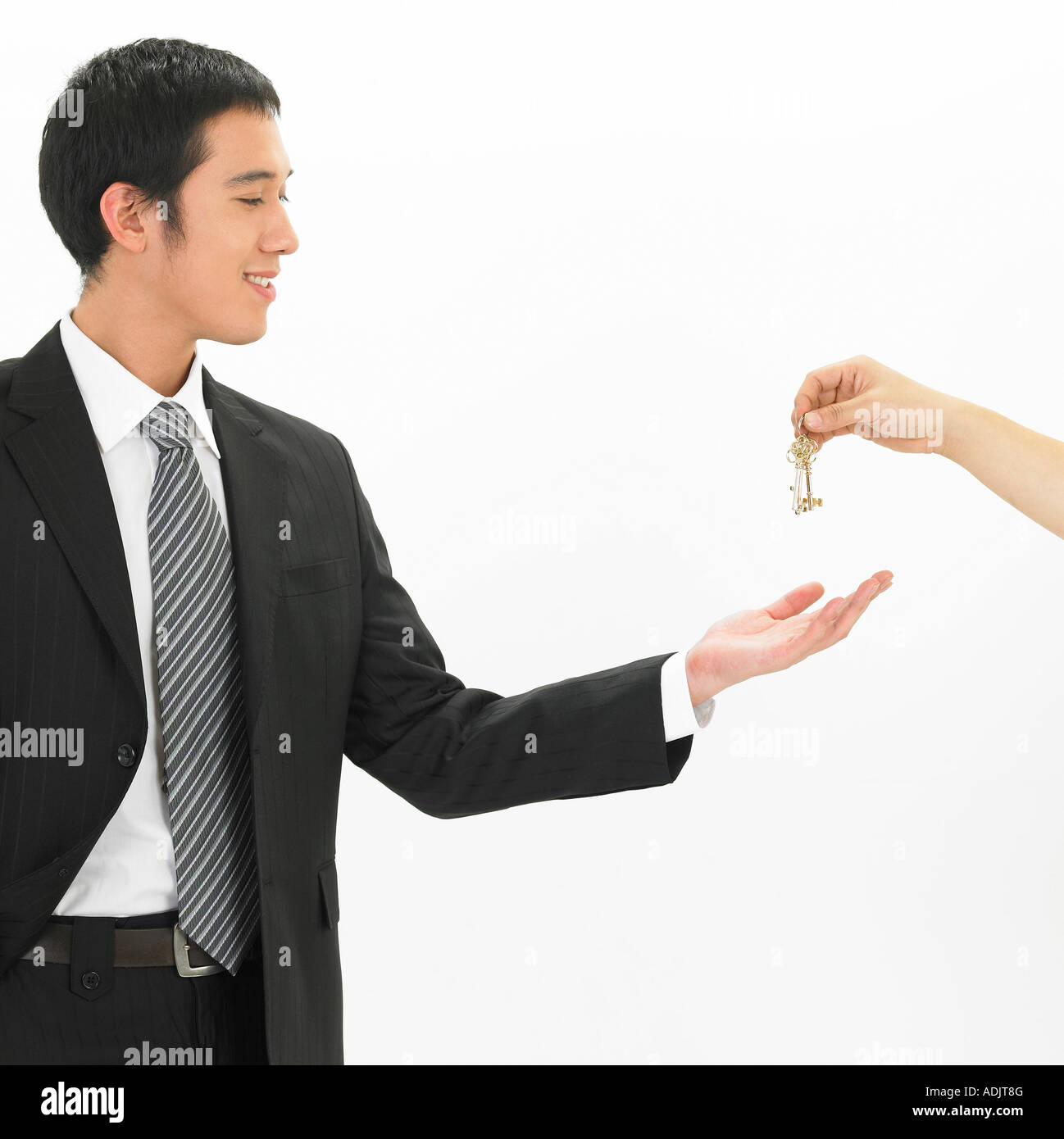 A man receiving a key from a woman Stock Photo - Alamy