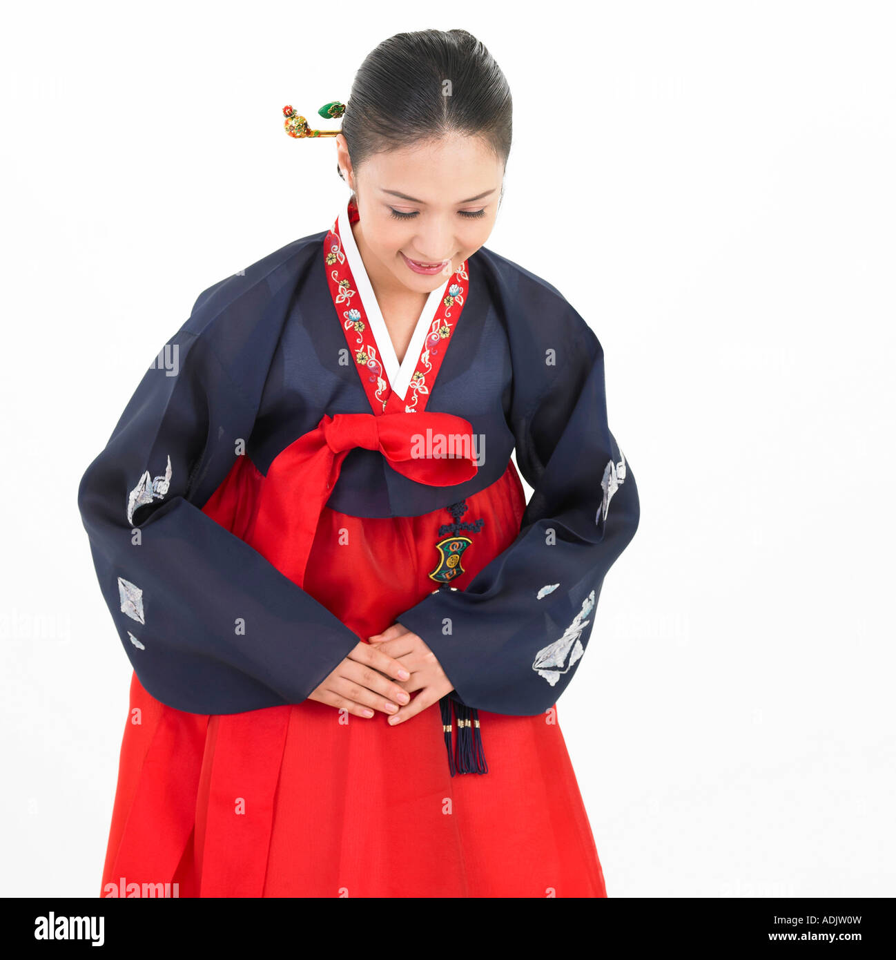A Korean woman wearing Hanboek is bowing politely Stock Photo - Alamy