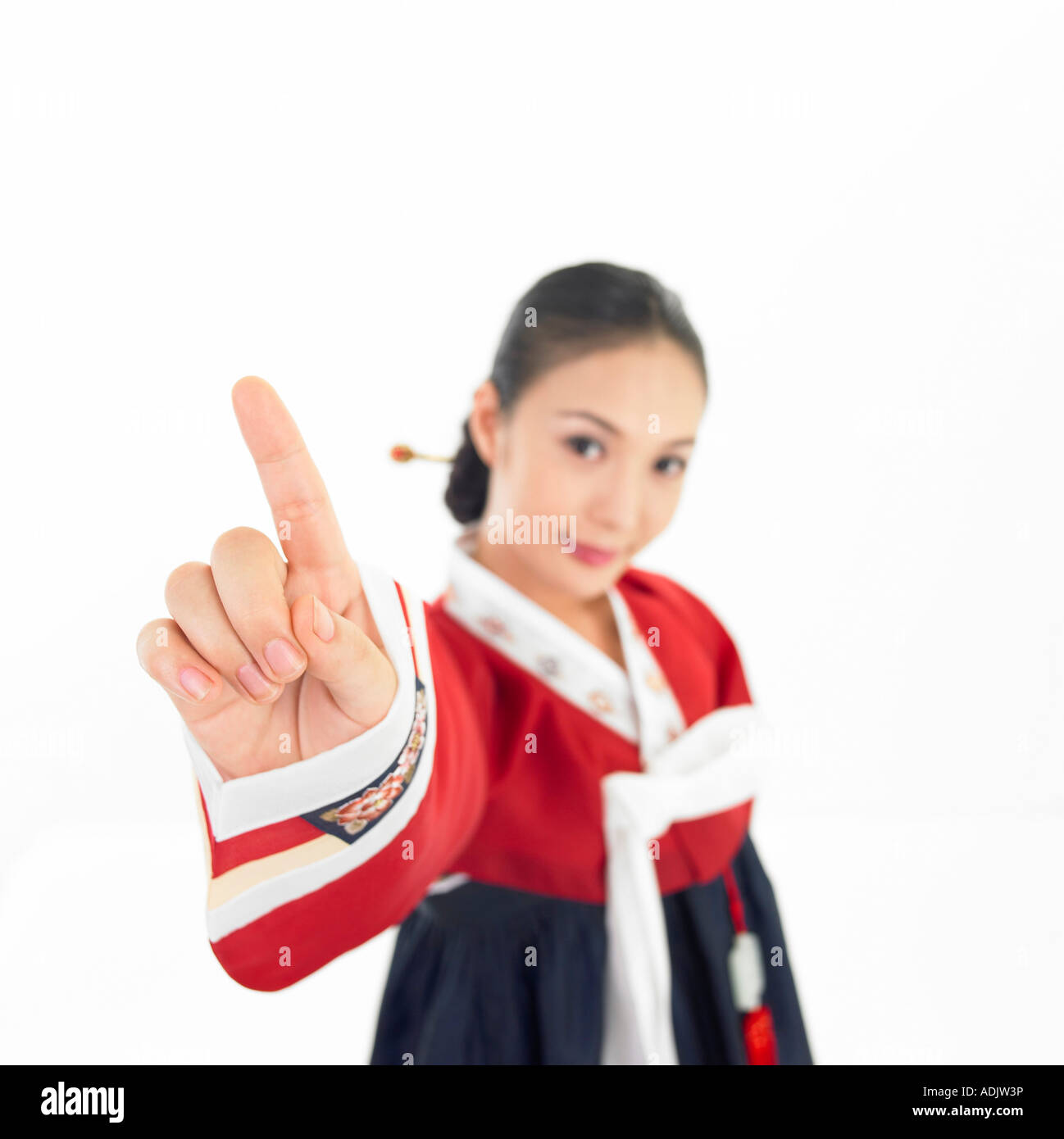 A Korean woman wearing Hanboek is pointing a finger Stock Photo - Alamy