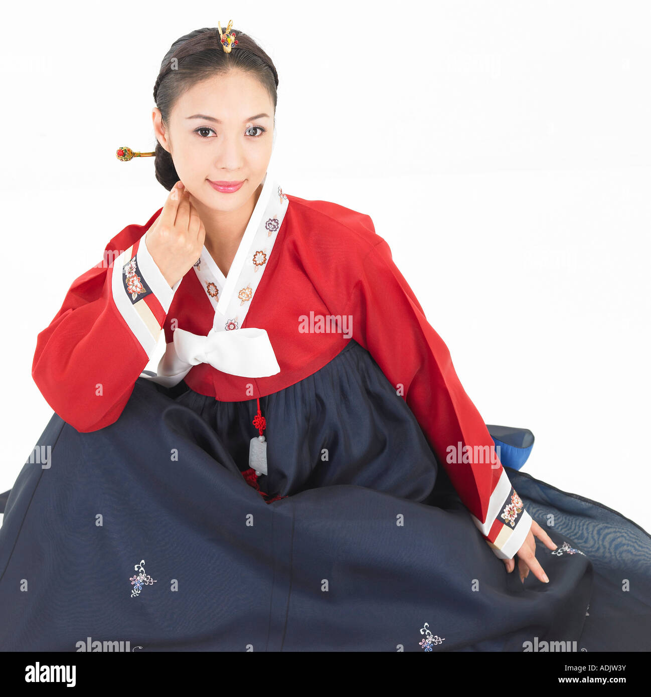 A Korean woman wearing Hanboek is sitting gracefully Stock Photo - Alamy