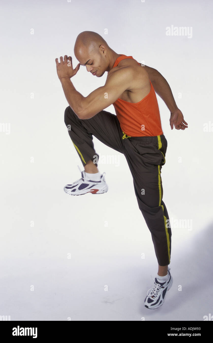 Side profile of young man lifting his leg Stock Photo - Alamy