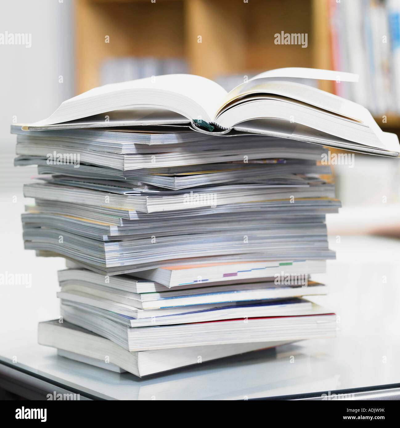 A opened book is on the piled books Stock Photo - Alamy