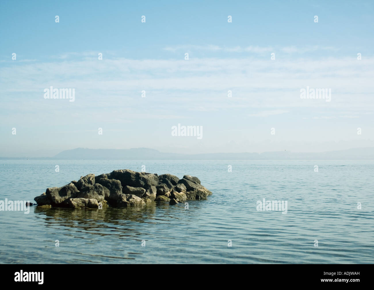 Group of stones in lake Stock Photo - Alamy