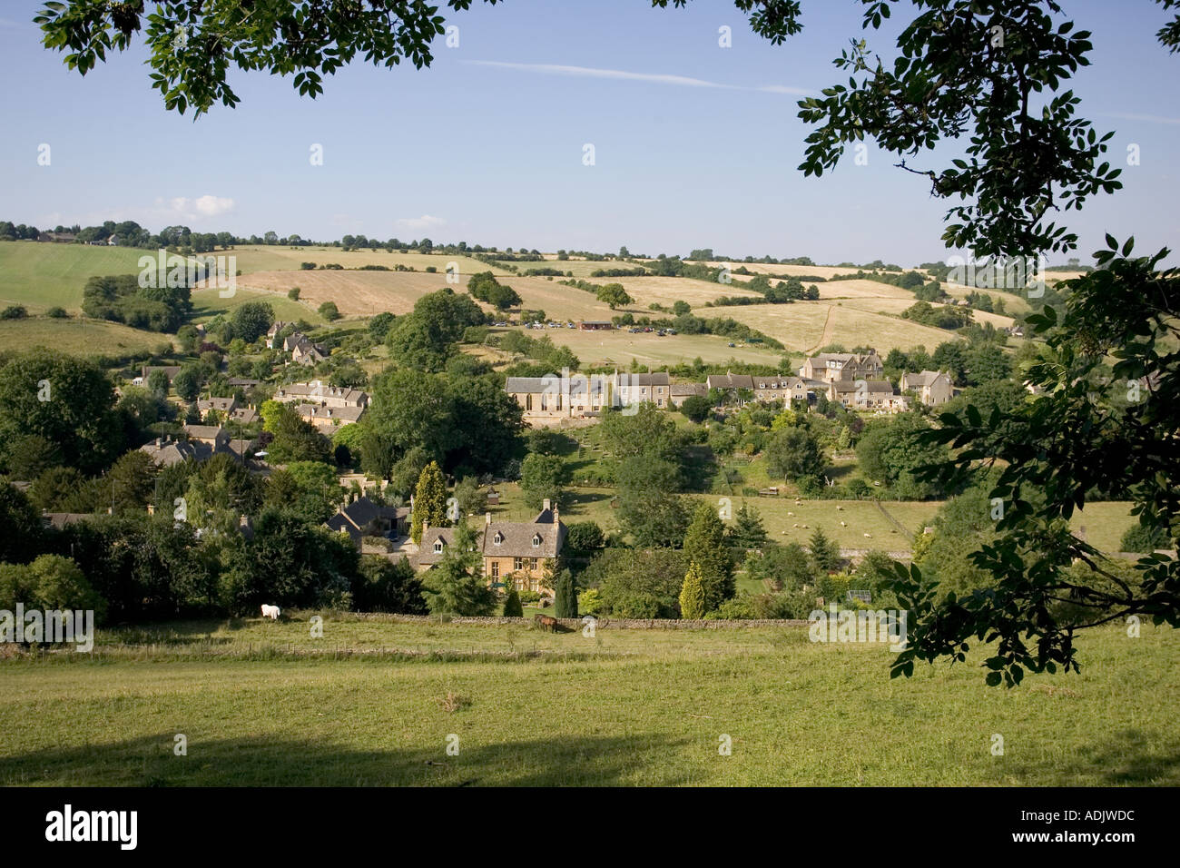 Cotswold village of Naunton across the Windrush Valley UK Stock Photo ...