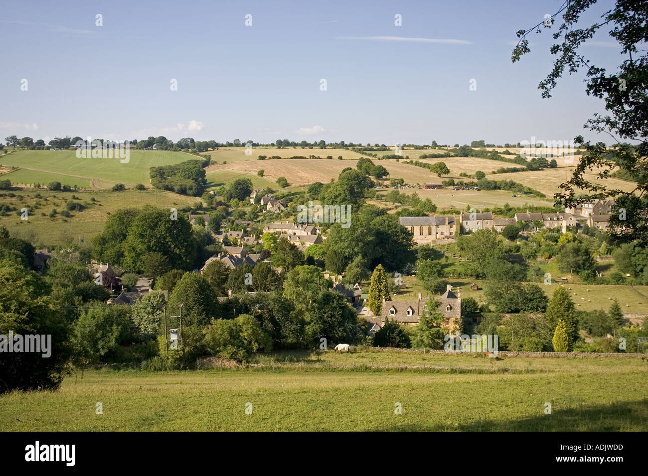Cotswold village of Naunton across the Windrush Valley UK Stock Photo ...