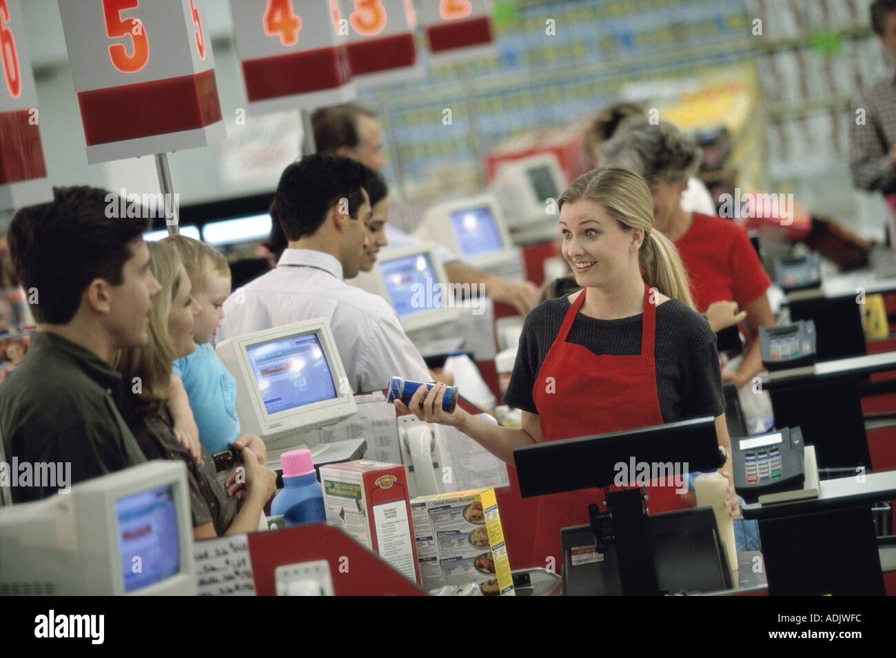 Customers standing at a checkout counter in a supermarket Stock Photo ...