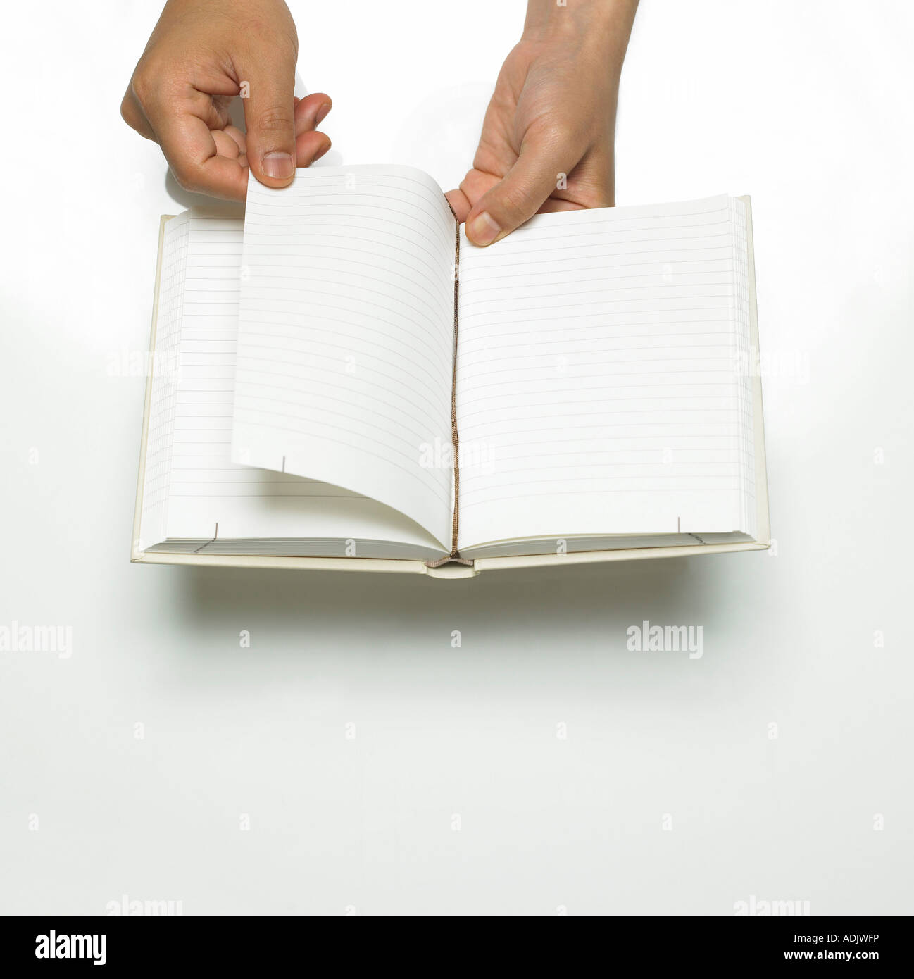 A hand holding a opened notebook Stock Photo - Alamy