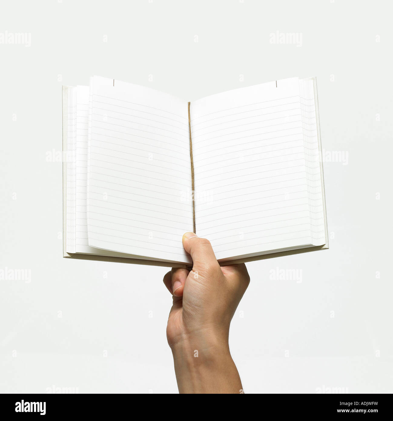 A hand holding a opened notebook Stock Photo - Alamy