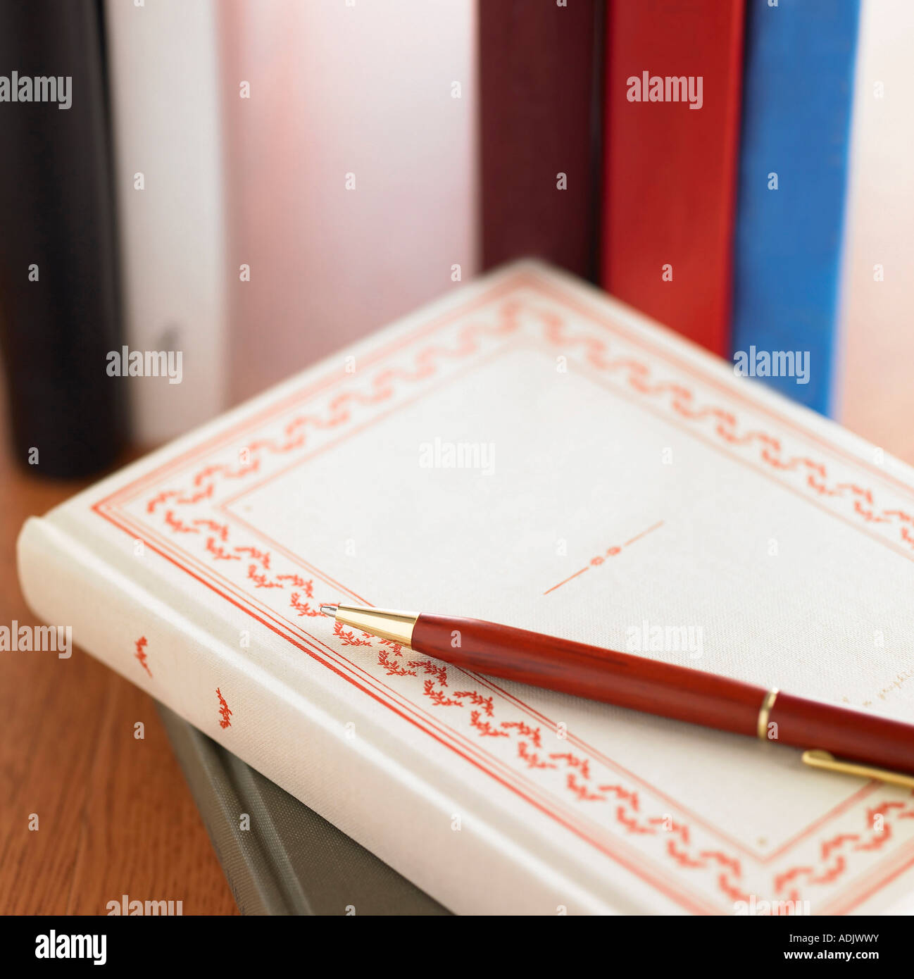 There are notebooks, books and a ball point pen on the desk Stock Photo ...