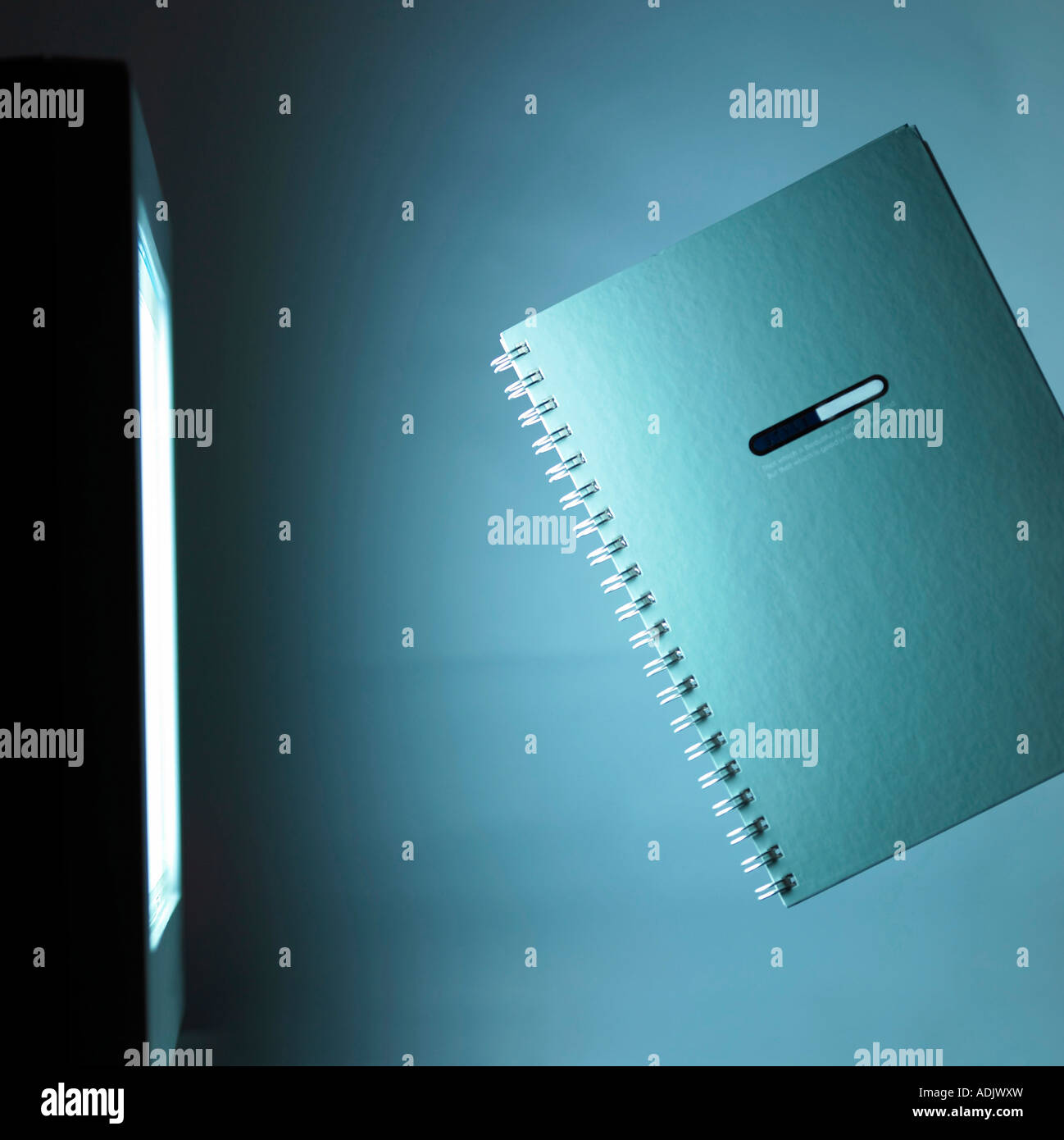 A monitor lighting a notebook Stock Photo - Alamy