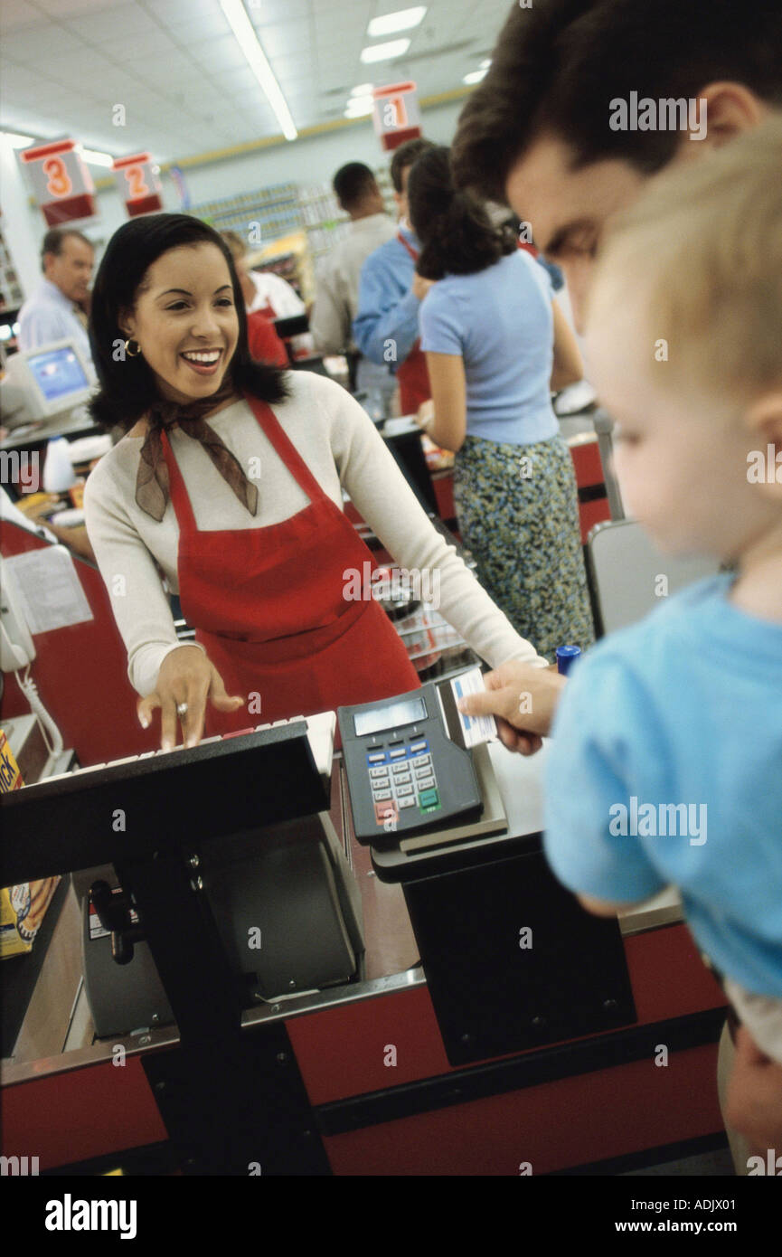 Father and his son at a checkout counter in a supermarket Stock Photo ...