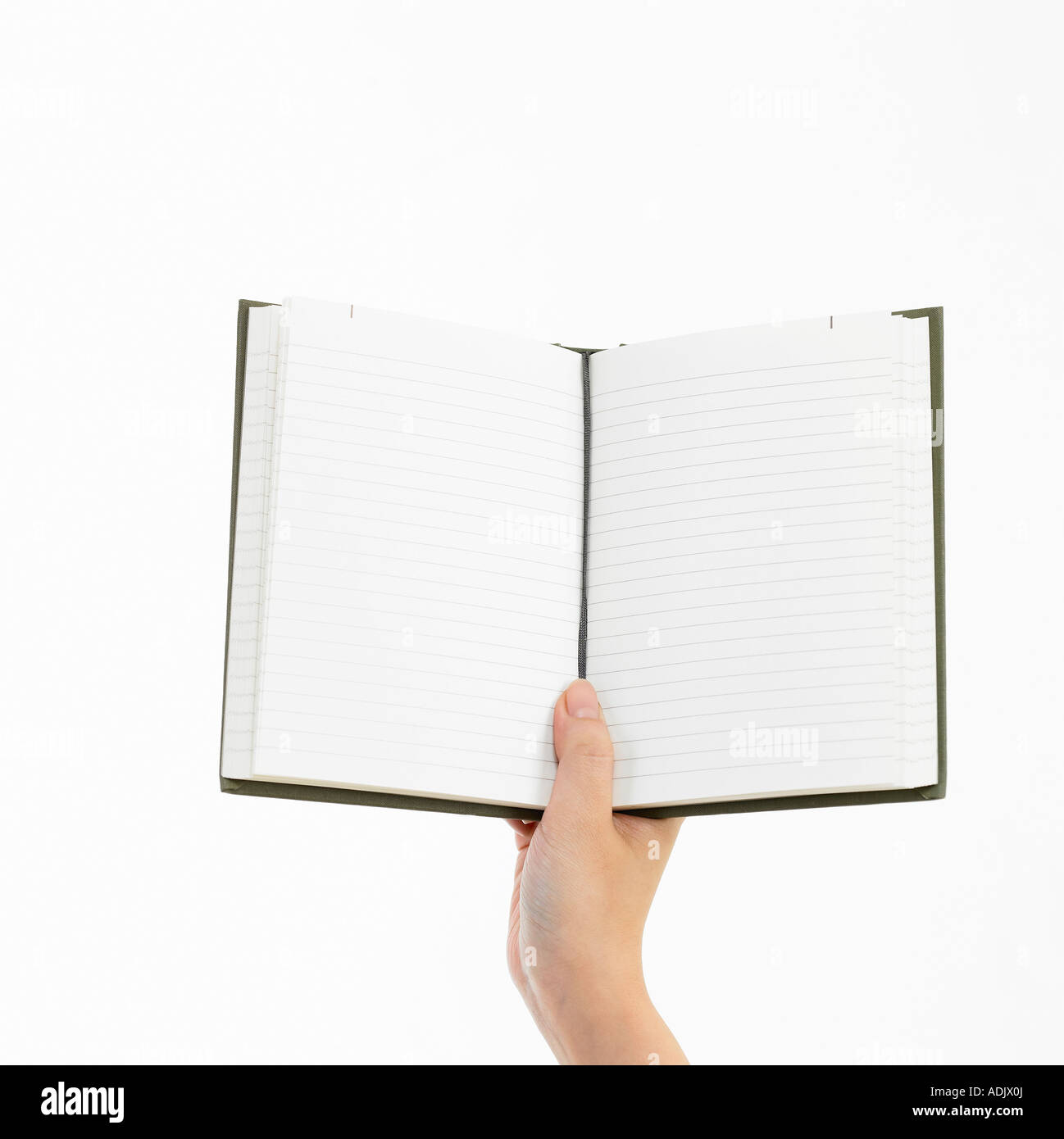 A hand holding a notebook Stock Photo - Alamy