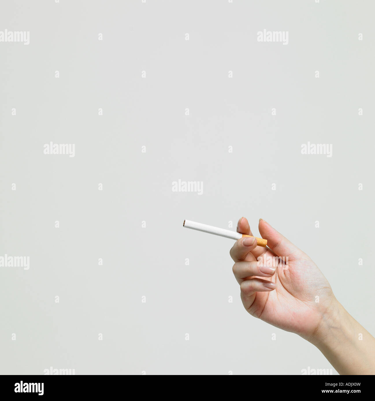 A hand holding cigarette Stock Photo - Alamy