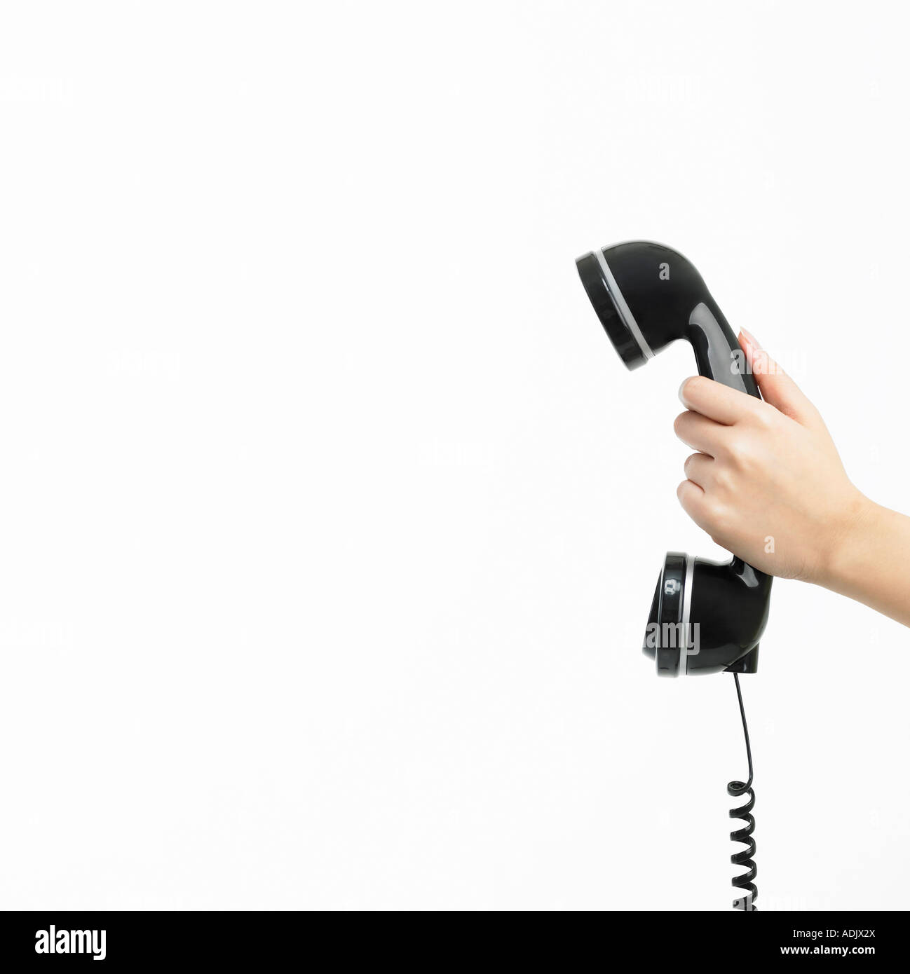 A hand holding telephone Stock Photo - Alamy