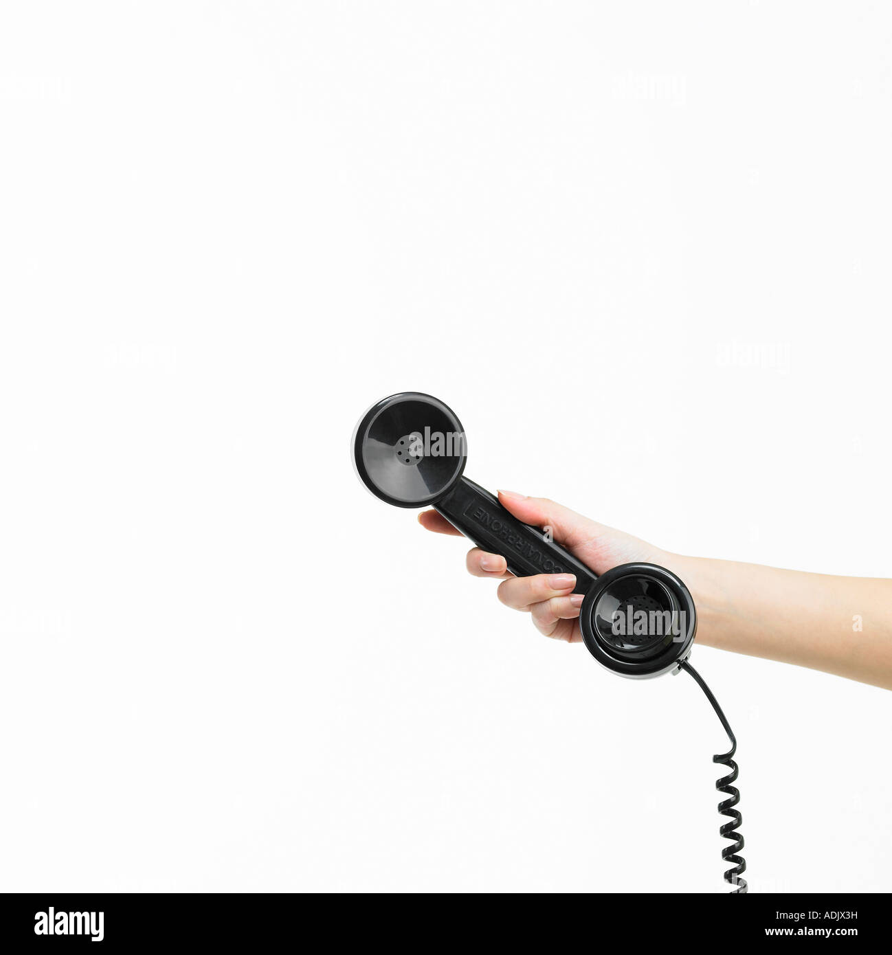 A hand holding telephone Stock Photo - Alamy