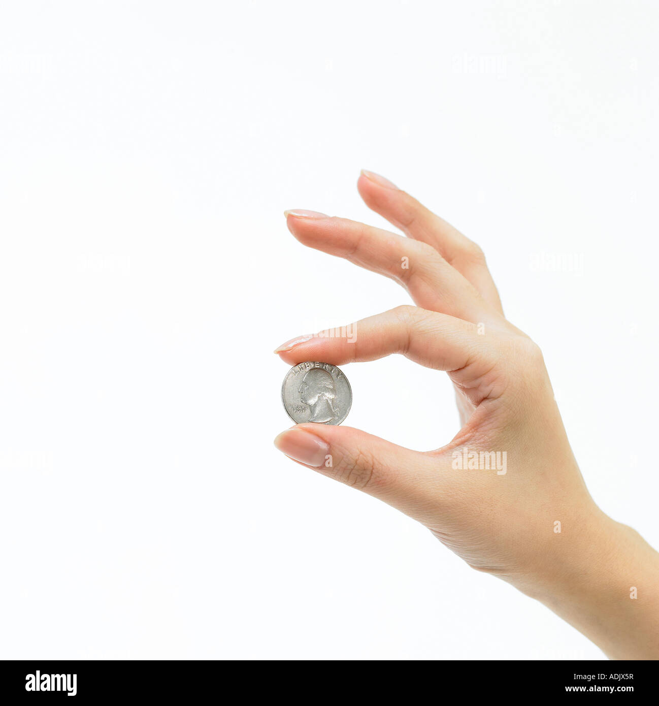 A hand holding a coin Stock Photo - Alamy