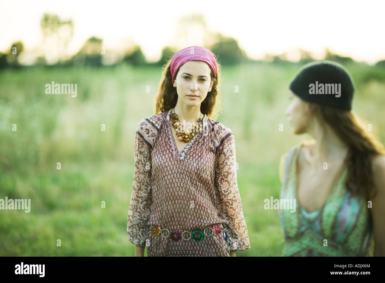 Young hippie women walking in field Stock Photo - Alamy