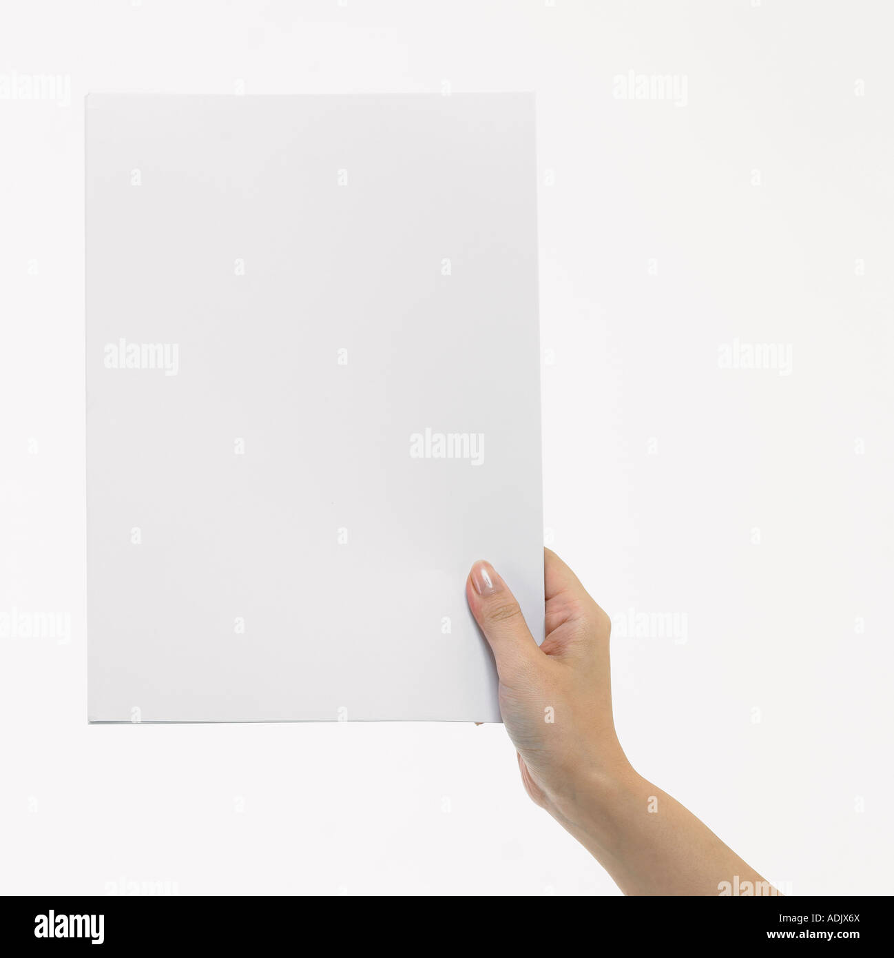 A hand holding a sheet of white paper Stock Photo - Alamy
