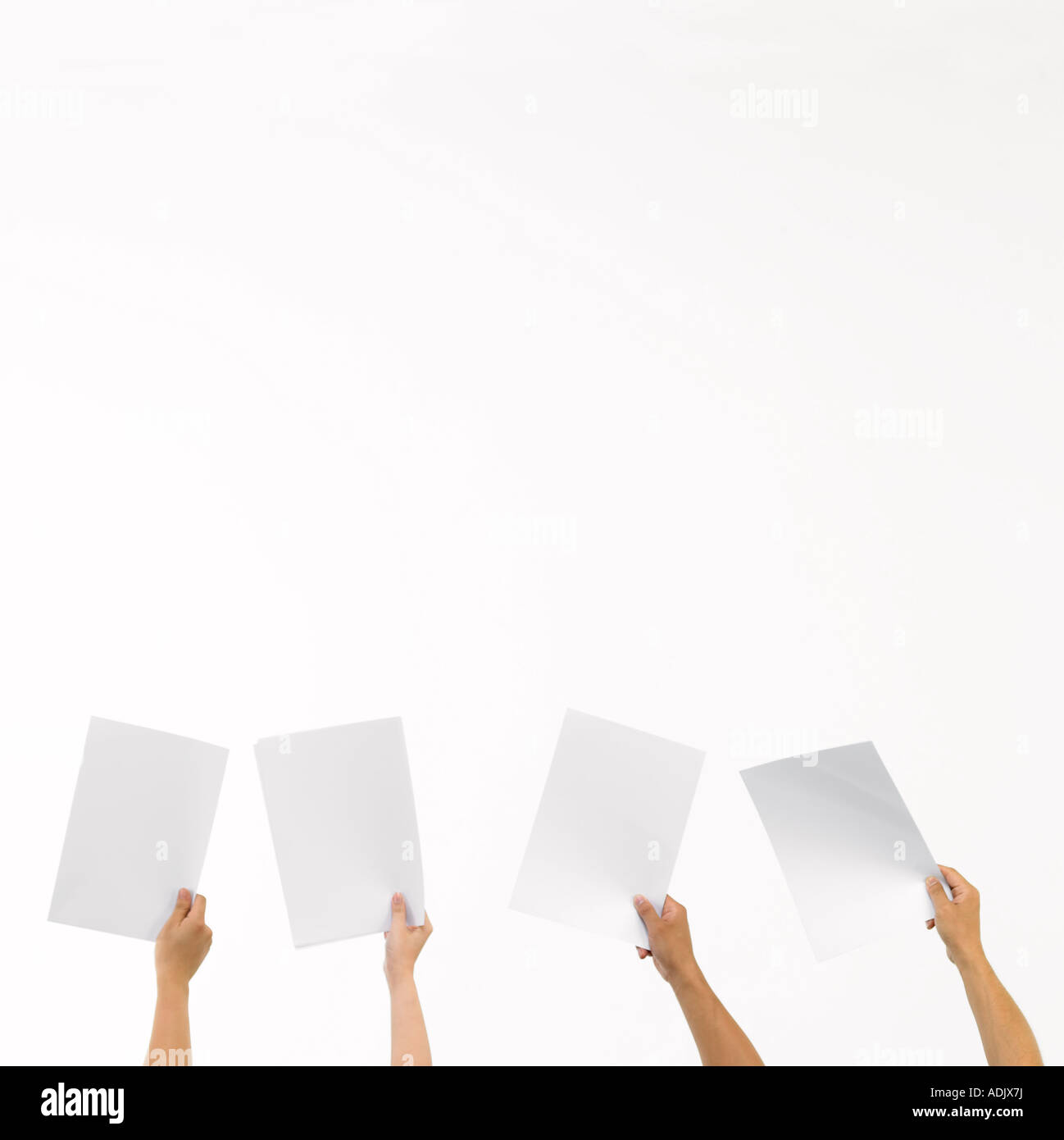 Many hands holding some white paper Stock Photo - Alamy