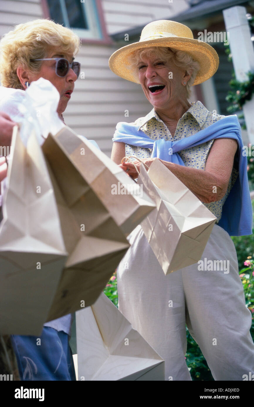 Senior women carrying shopping bags hi-res stock photography and images ...