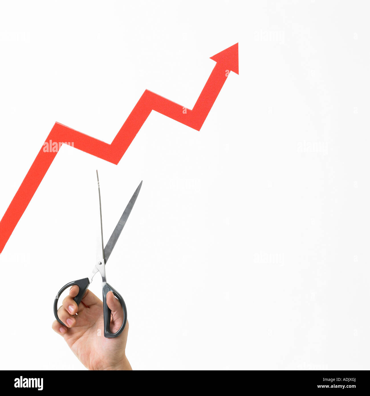 A hand cutting an arrow with scissors Stock Photo - Alamy