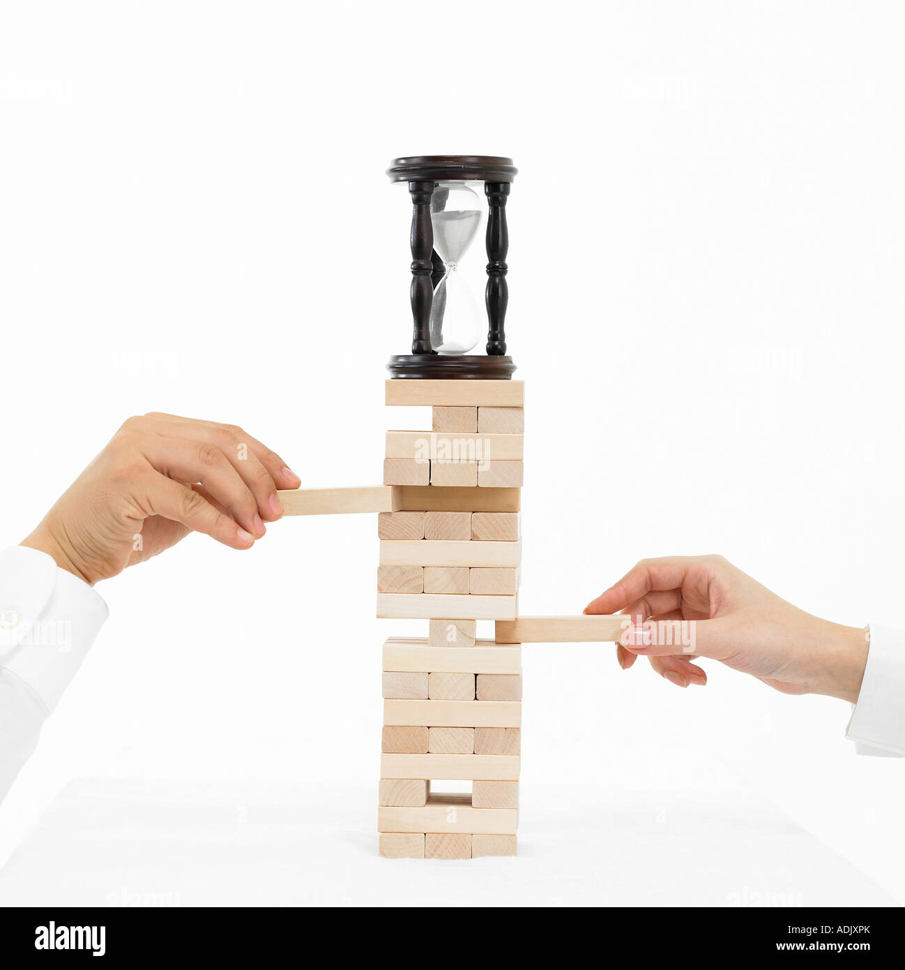 Two hands playing a game with a sand glass Stock Photo - Alamy