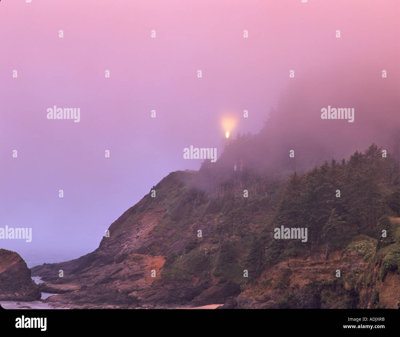 Lighthouse and rocky shoreline in fog hi-res stock photography and ...