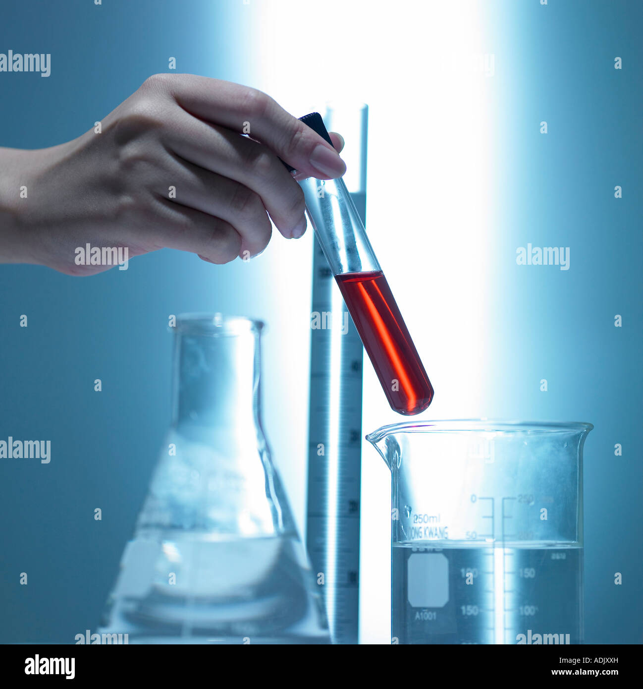 A hand making a chemical experiment in the laboratory Stock Photo - Alamy