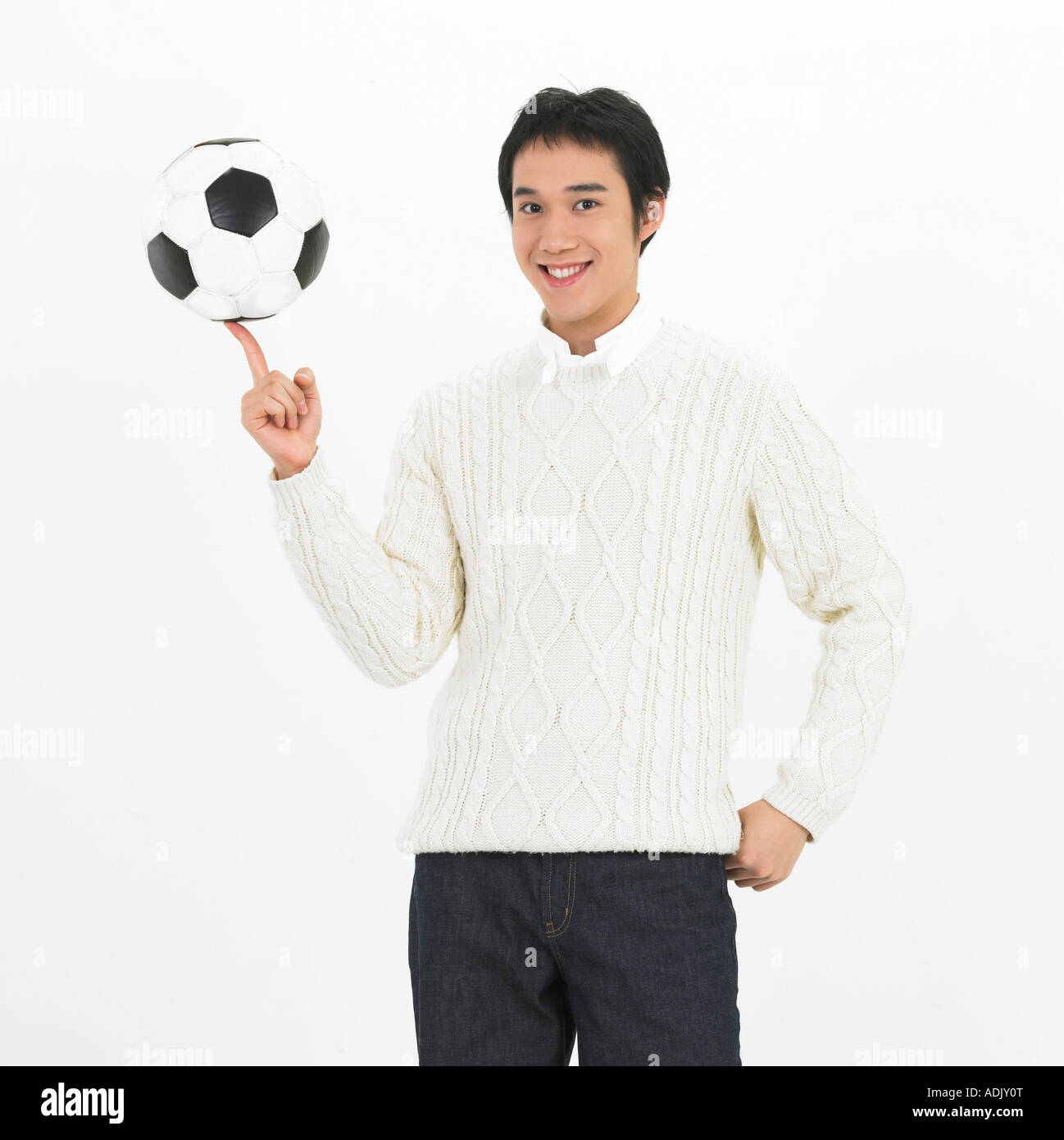 A man holding a soccer ball with a smile Stock Photo - Alamy