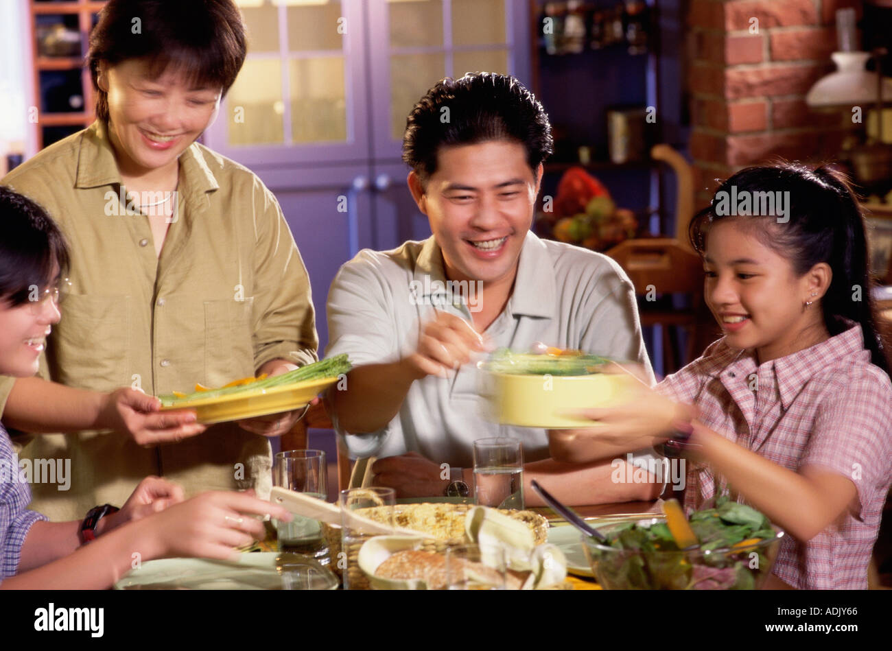 Parents with their children at a dining table Stock Photo - Alamy