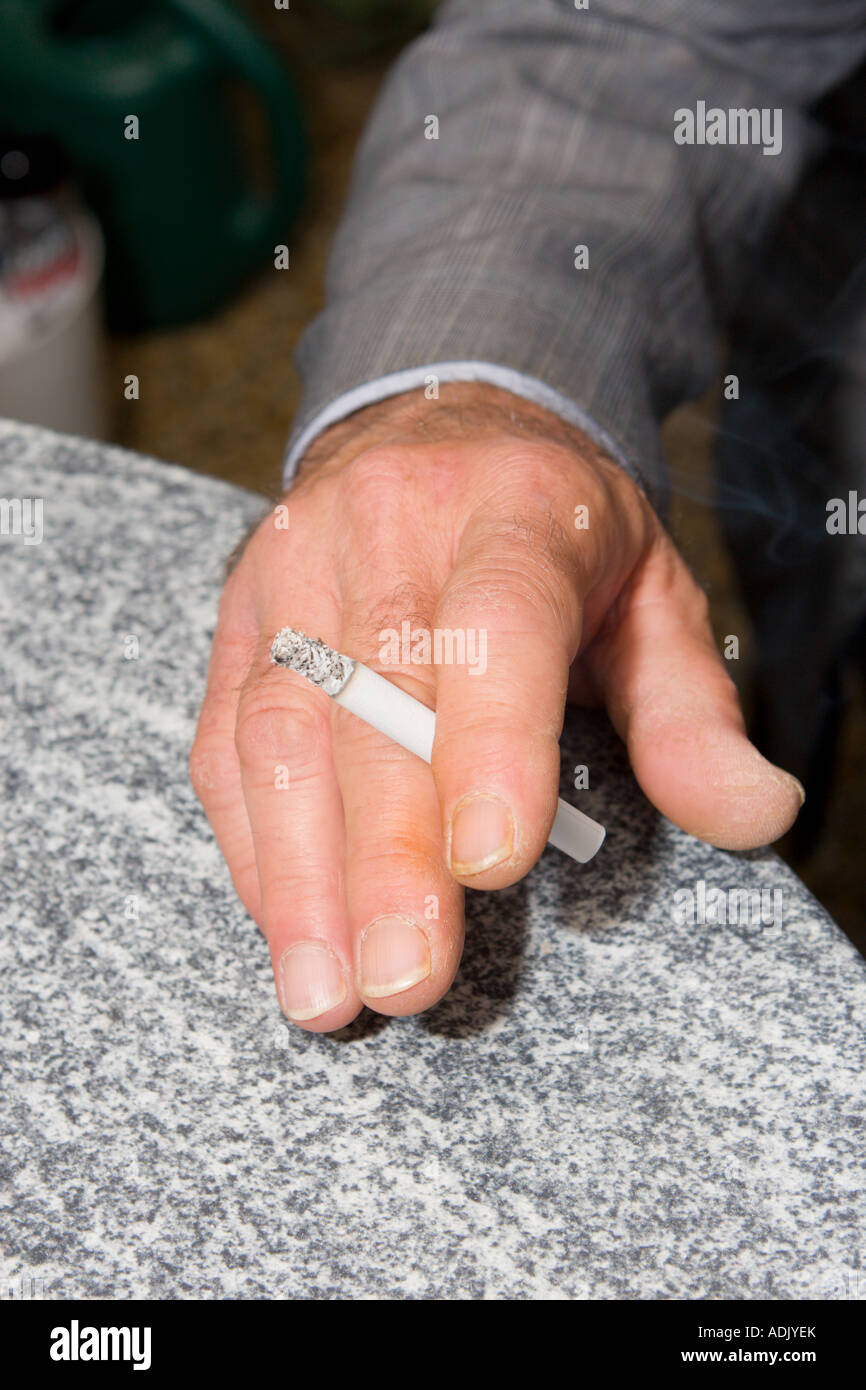 Hand Holding a lit Cigarette Stock Photo - Alamy