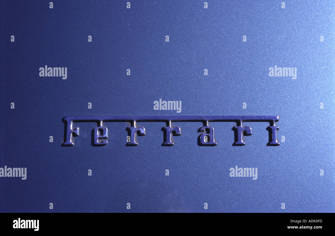 ferrari logo on blue paint background Stock Photo - Alamy