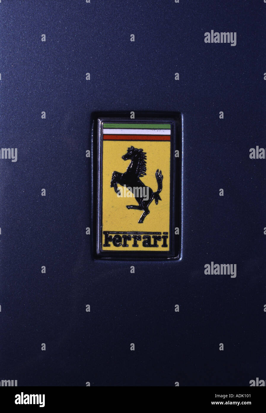 ferrari logo on blue paint background Stock Photo - Alamy