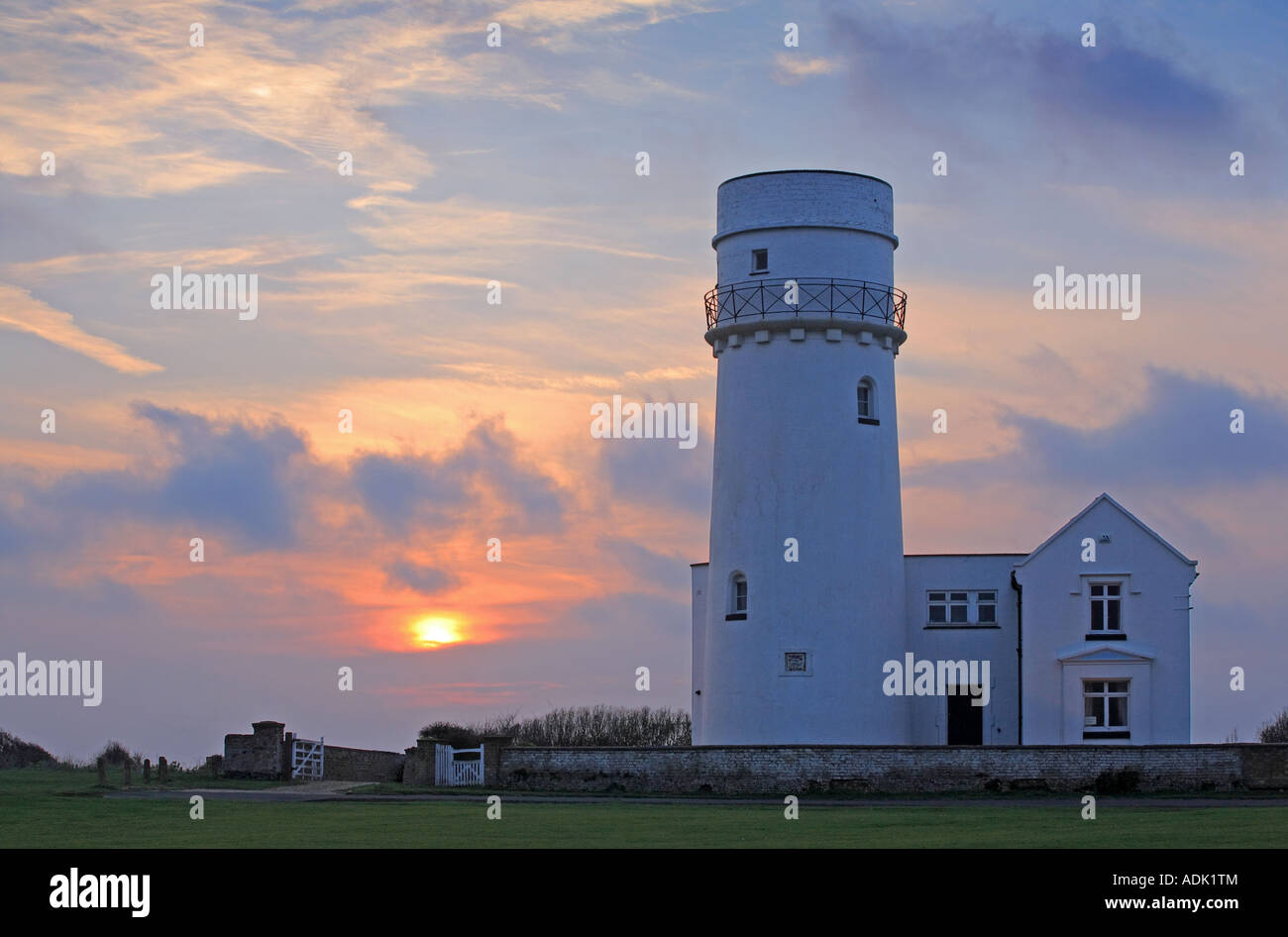 Hunstanton lighthouse on the Norfolk coast with the sun setting behind ...