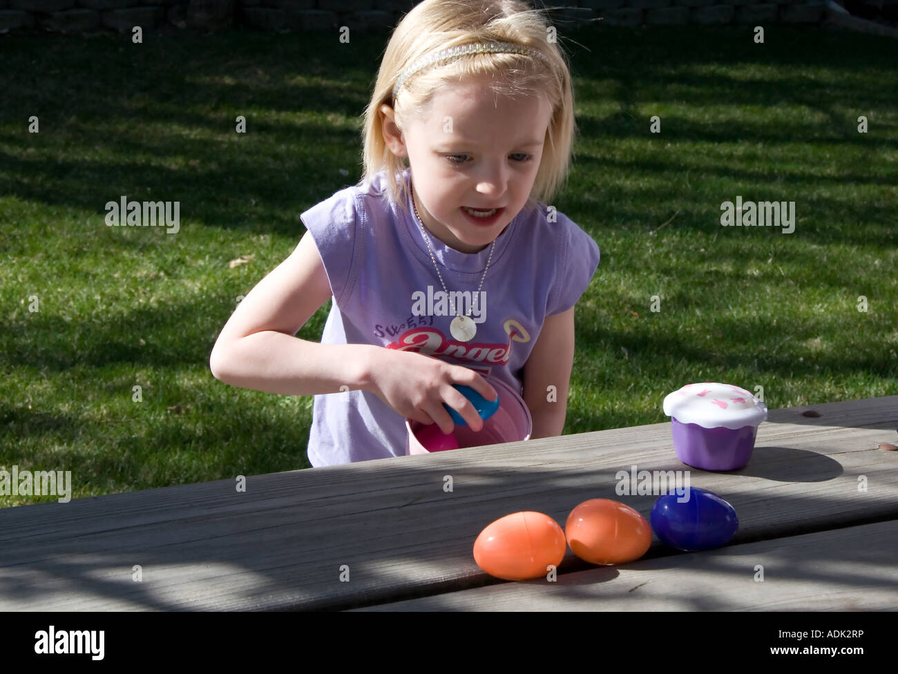 A young girl counts her eggs after a fruitful Easter egg hunt Stock ...