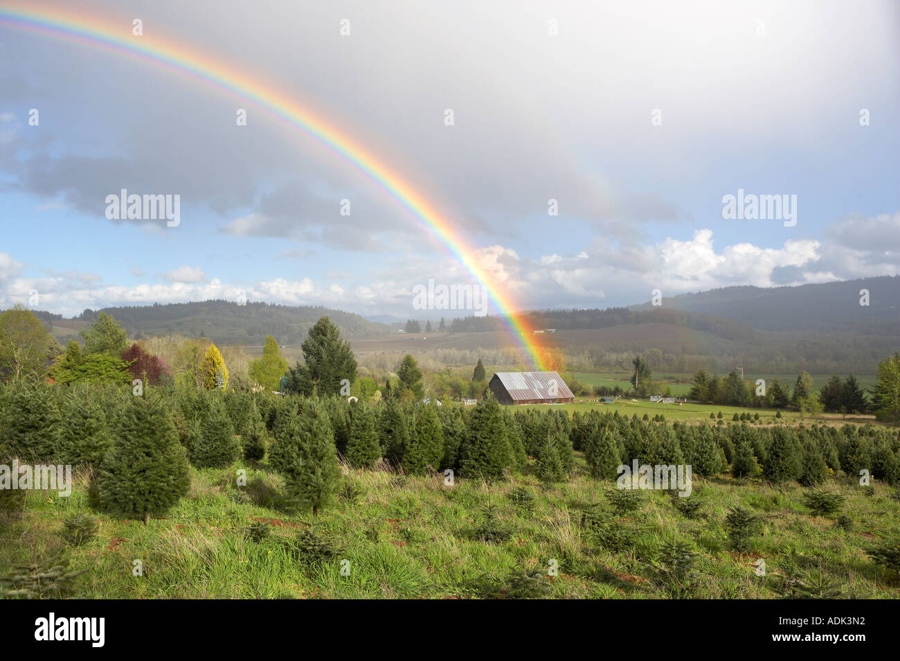 Thunderstorm clouds with rainbow and barn over Monroe Oregon Stock ...