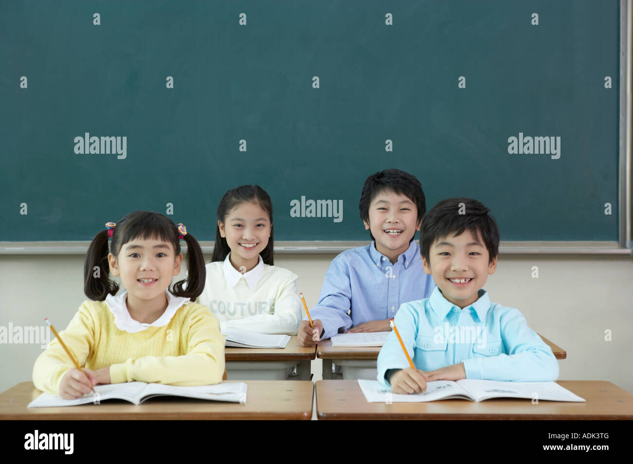 Smiling students in the class Stock Photo - Alamy