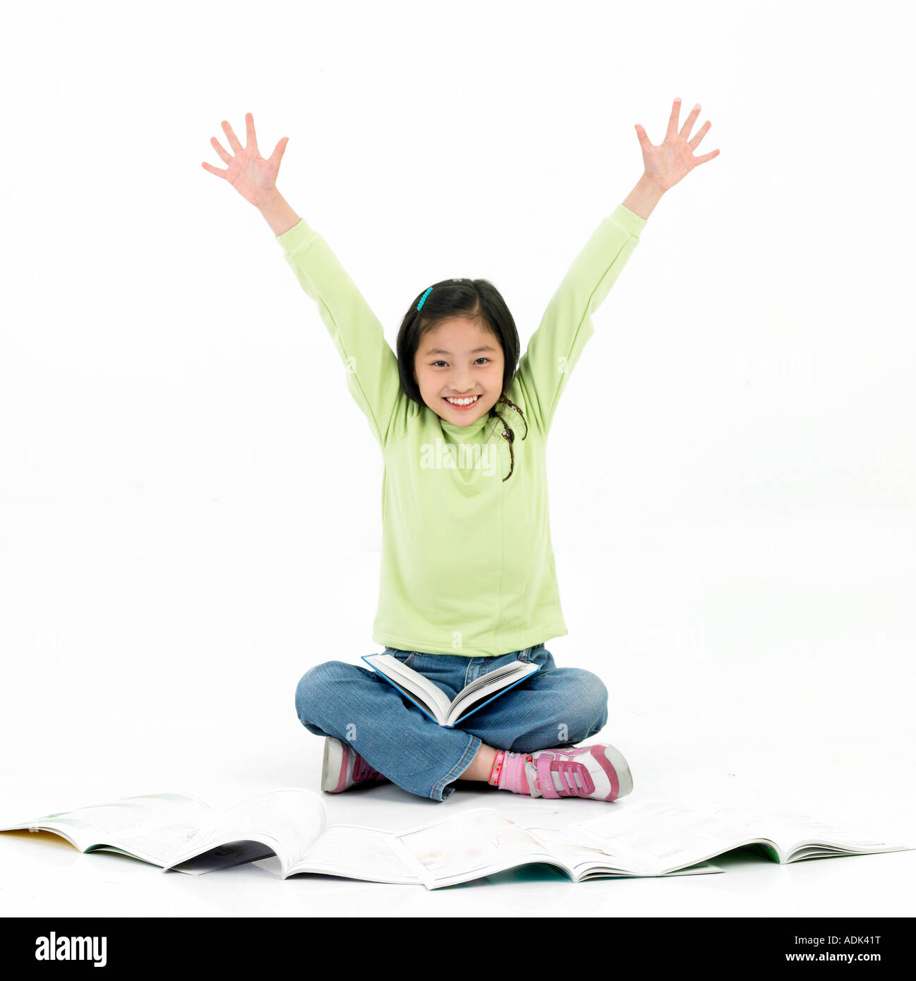 a girl raising her hands with a smile Stock Photo - Alamy