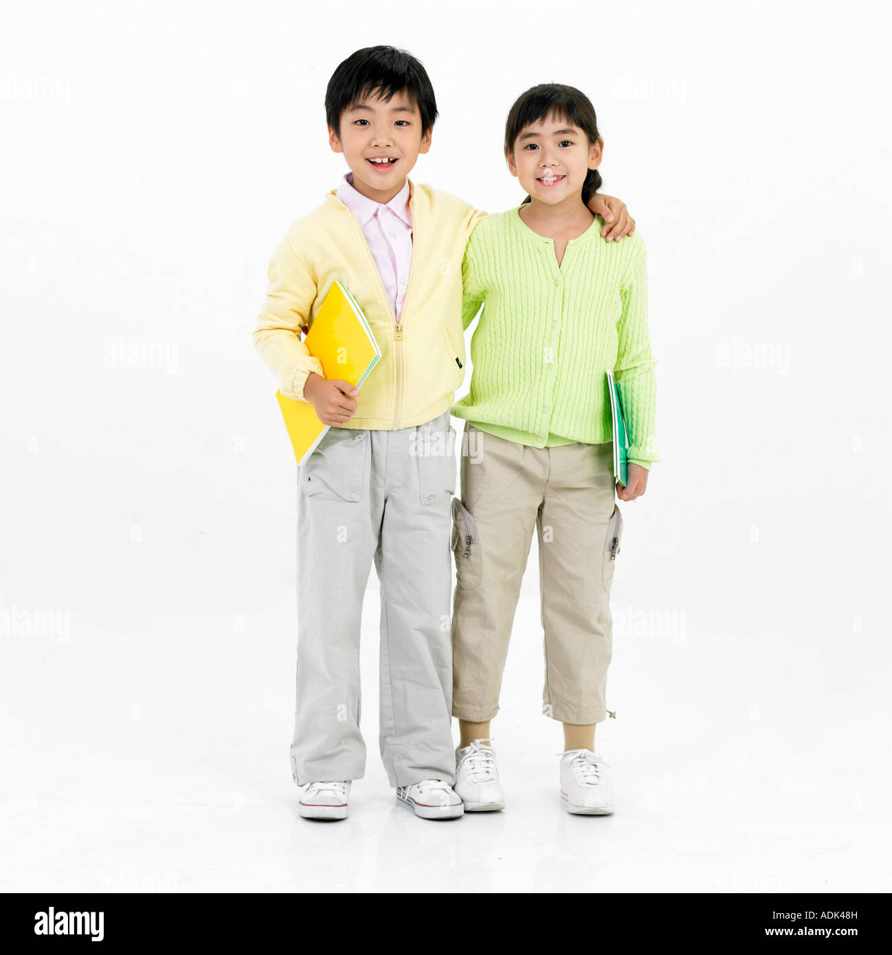 a girl and a boy putting arms around each other's shoulders with a ...